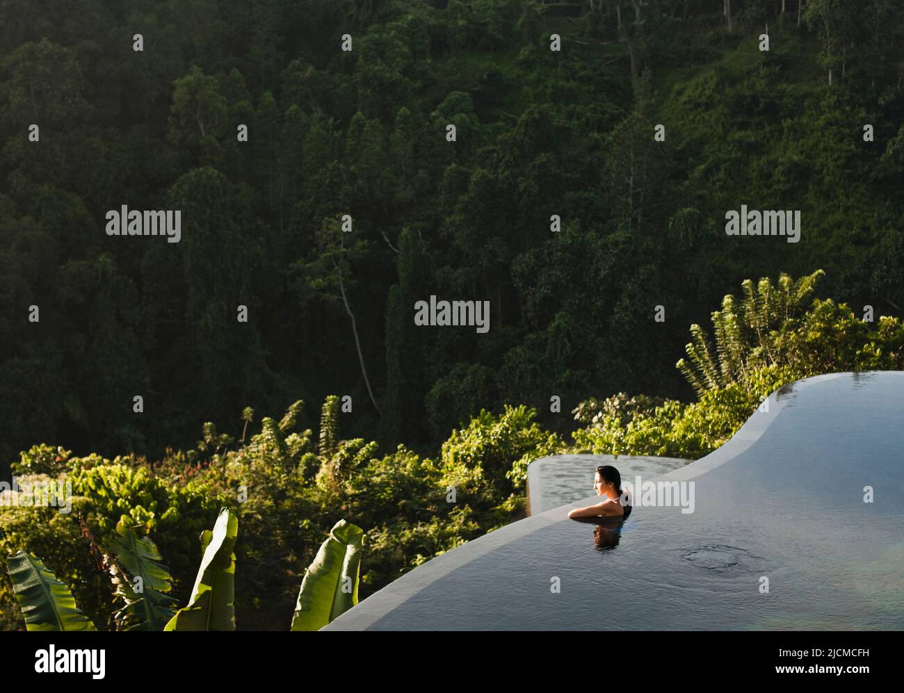 Female guest in two-tier infinity pool at Ubud Hanging Gardens, Bali ...
