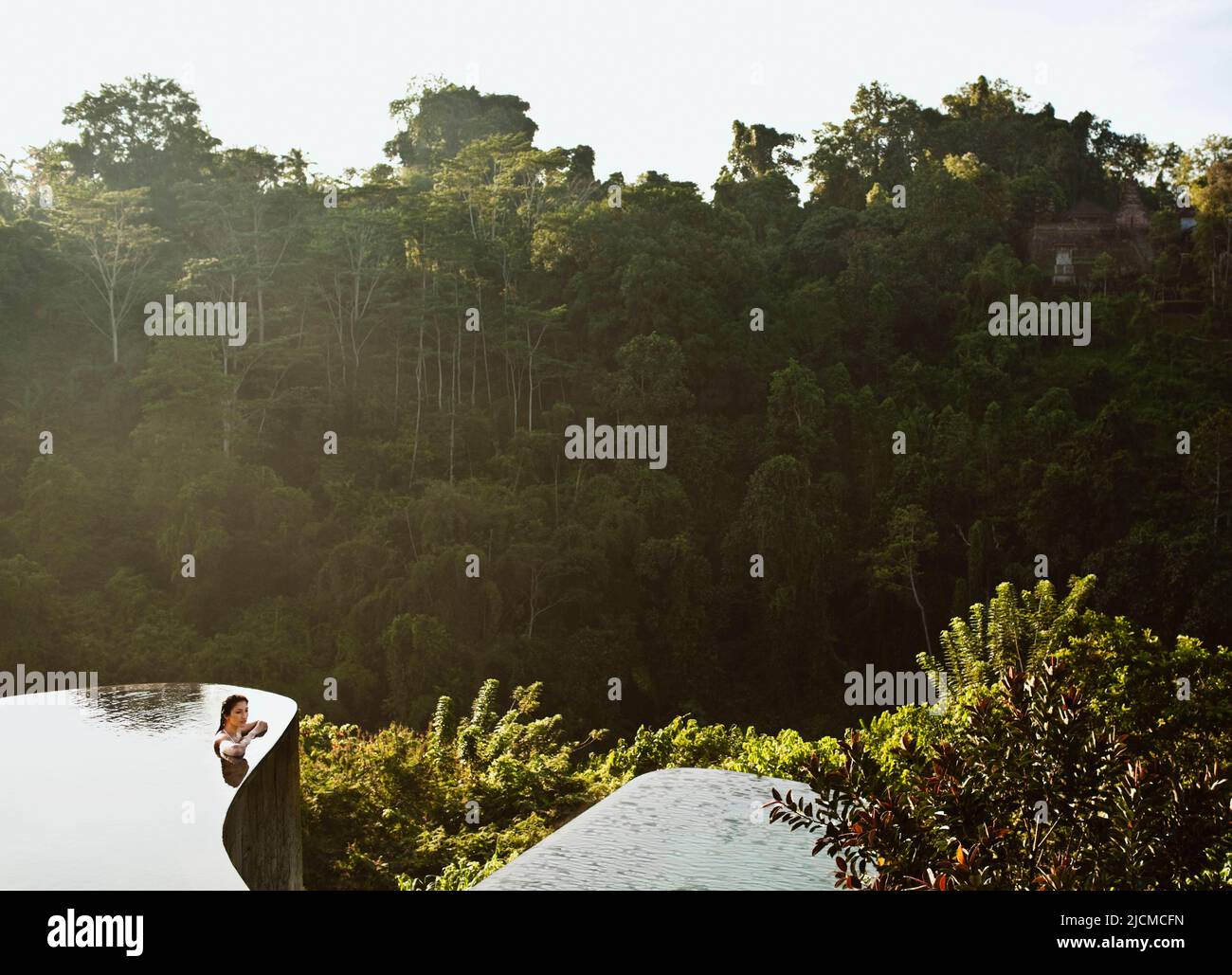 Female guest in two-tier infinity pool at Ubud Hanging Gardens, Bali ...