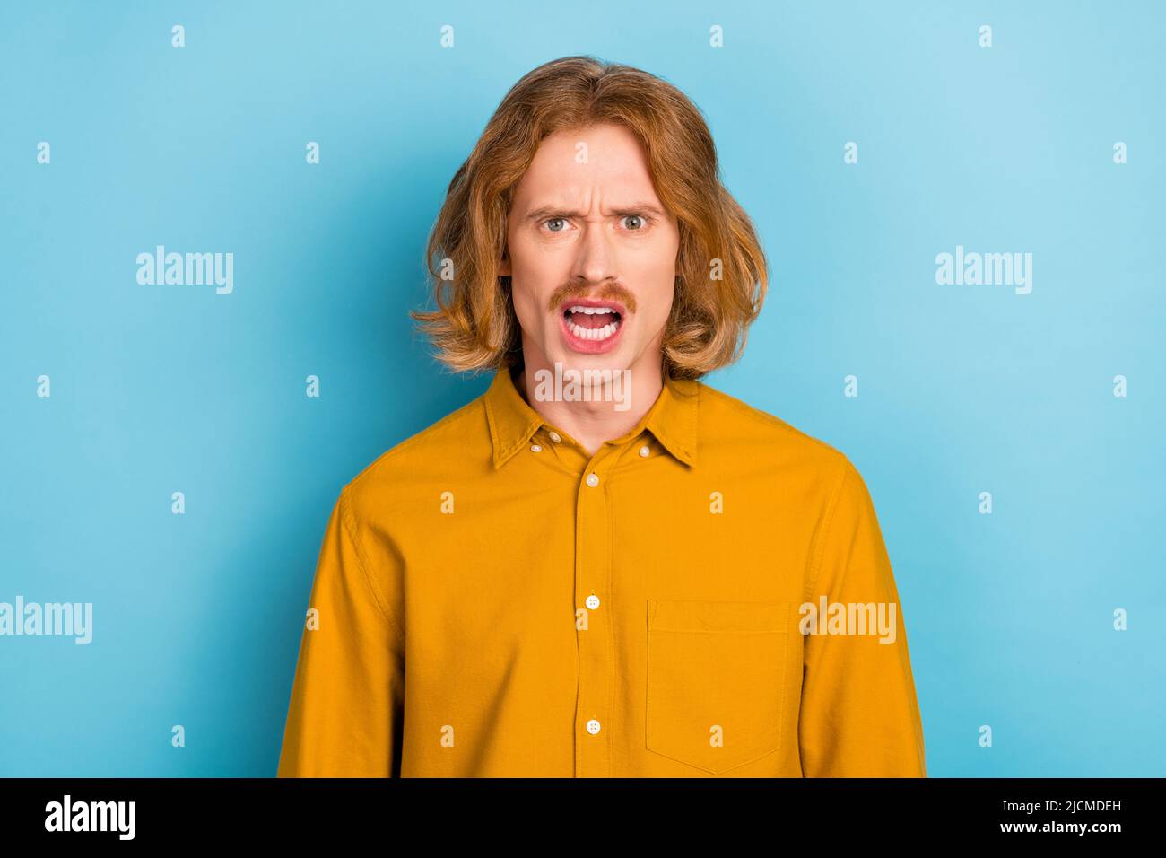 Portrait of attractive mad evil long-haired guy negative reaction ...