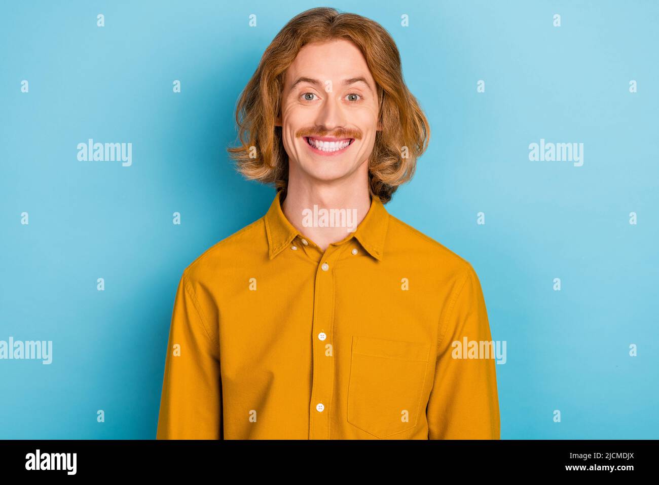 Portrait of attractive cheerful red-haired guy wearing mustard shirt ...