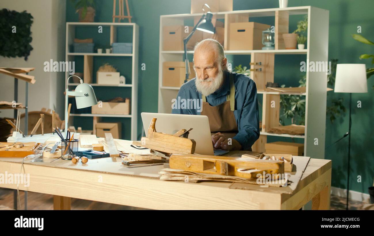 A Focused Carpenter Develops Layouts from Wood, Models 3D Sketches ...