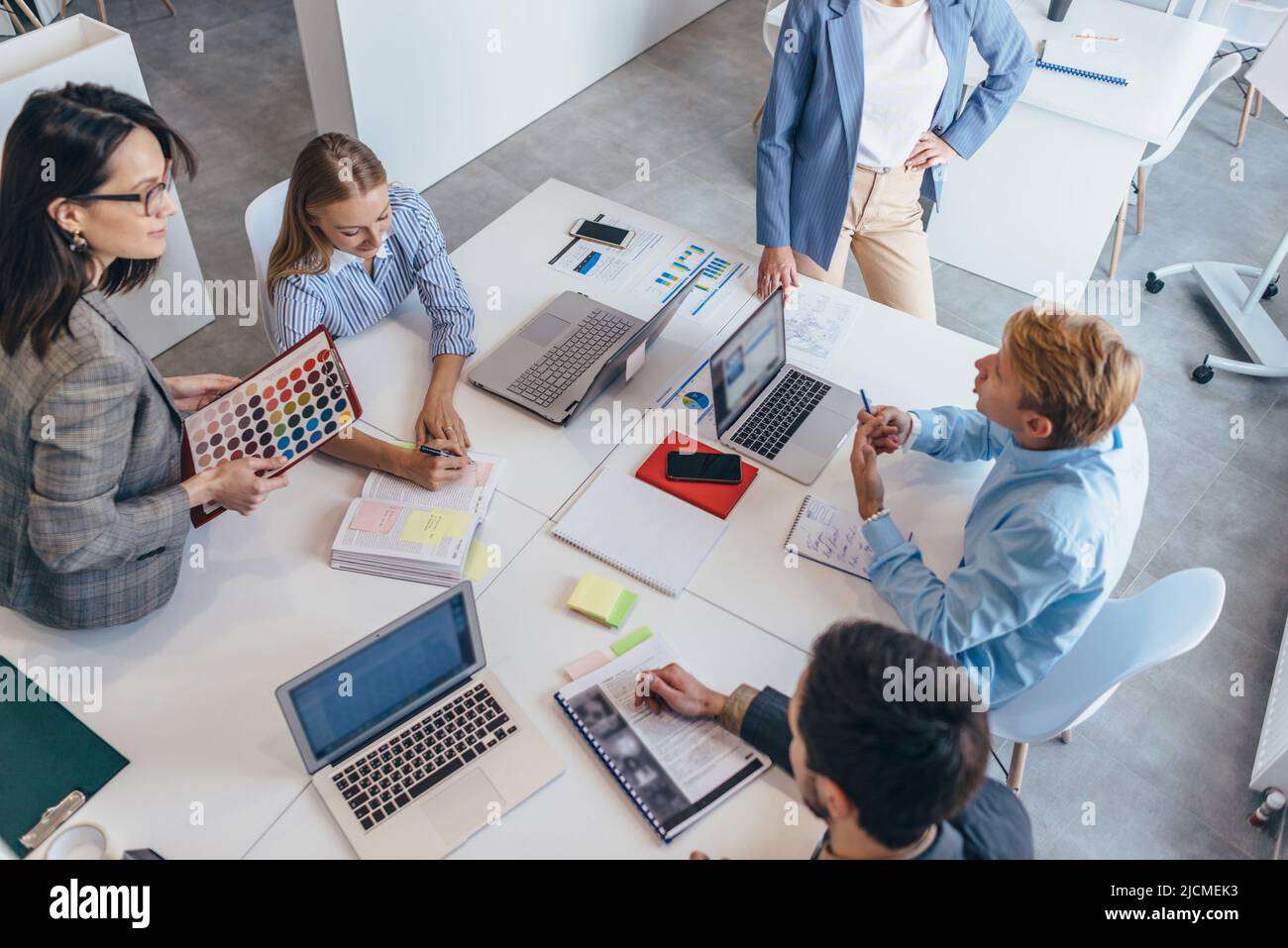 Group of people sitting in office working together on a project Stock ...
