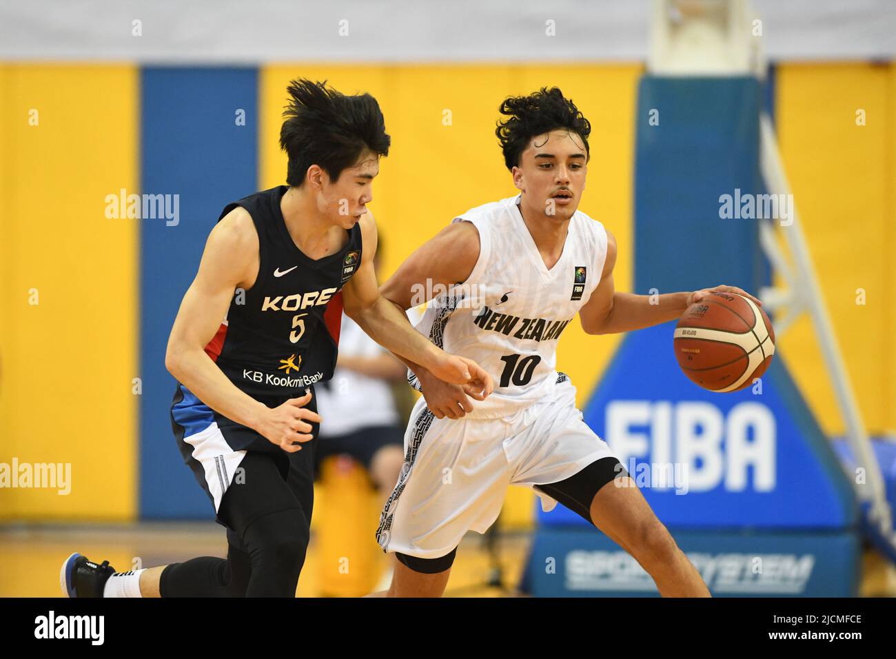 Doha, Qatar. 14th June, 2022. Chan You Ko (L) of Korea Basketball team ...
