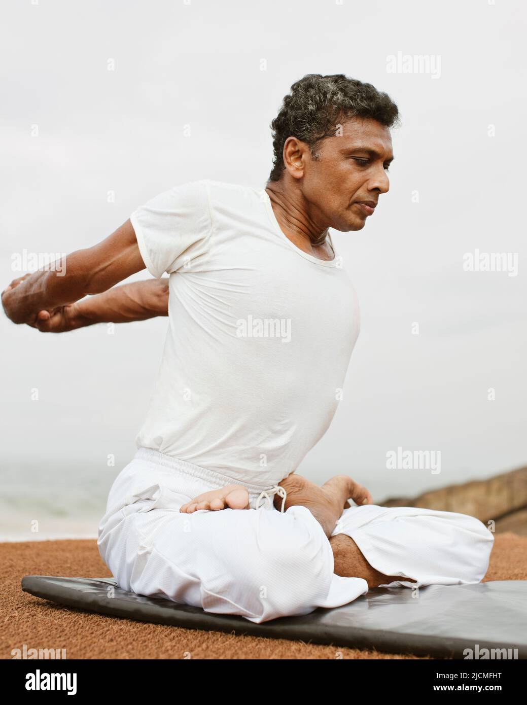 Sri Lankan yoga master practicing forward bends, in psychic union pose ...