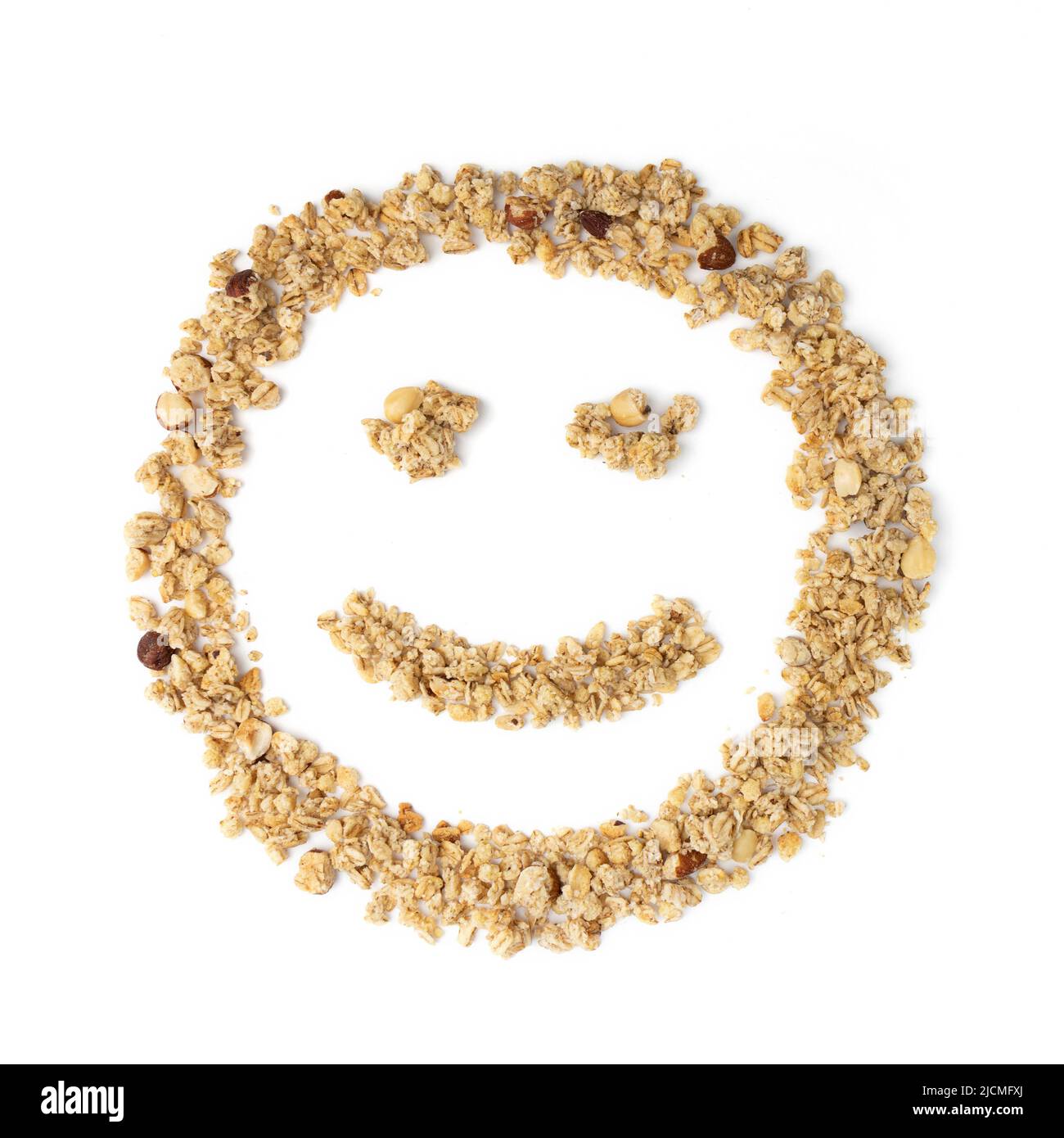 crunchy granola breakfast in the shape of smiling face on white ...