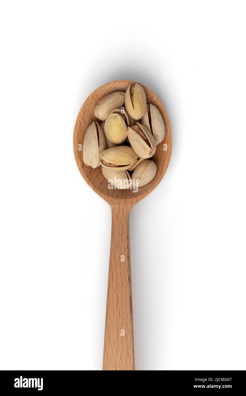 wooden spoon of pistachio with shell isolated on white background ...