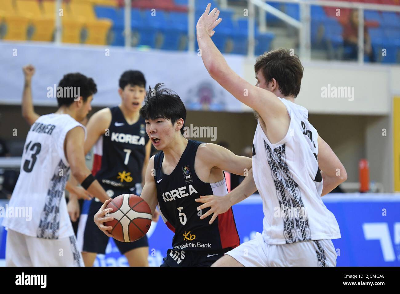 Doha, Qatar. 14th June, 2022. Chan You Ko (L) of Korea Basketball team ...