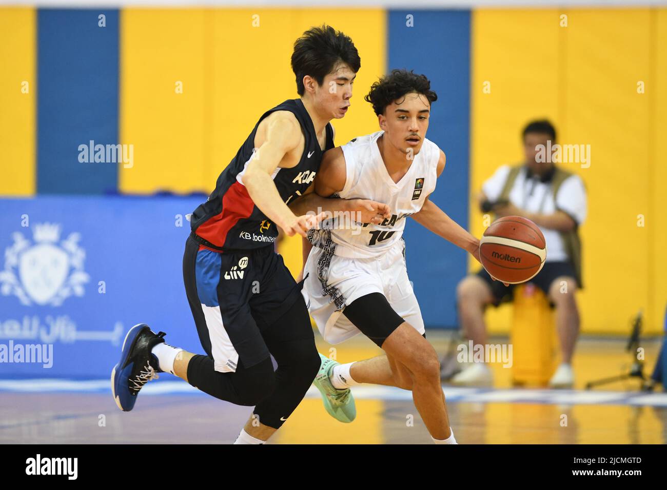 Doha, Qatar. 14th June, 2022. Chan You Ko (L) of Korea Basketball team ...