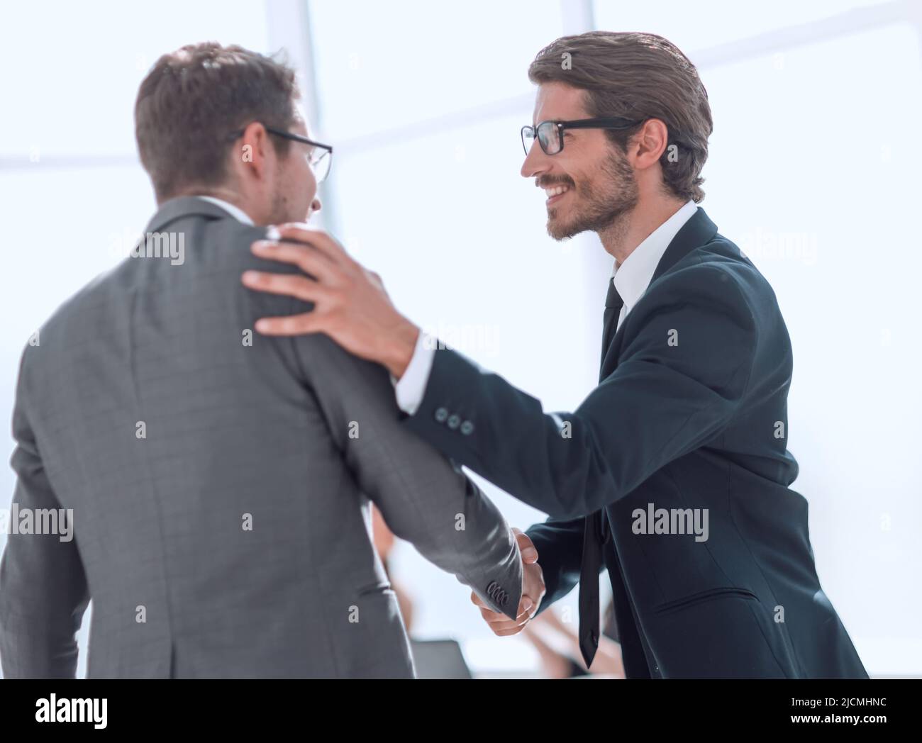 smiling business people greet each other with a handshake Stock Photo ...