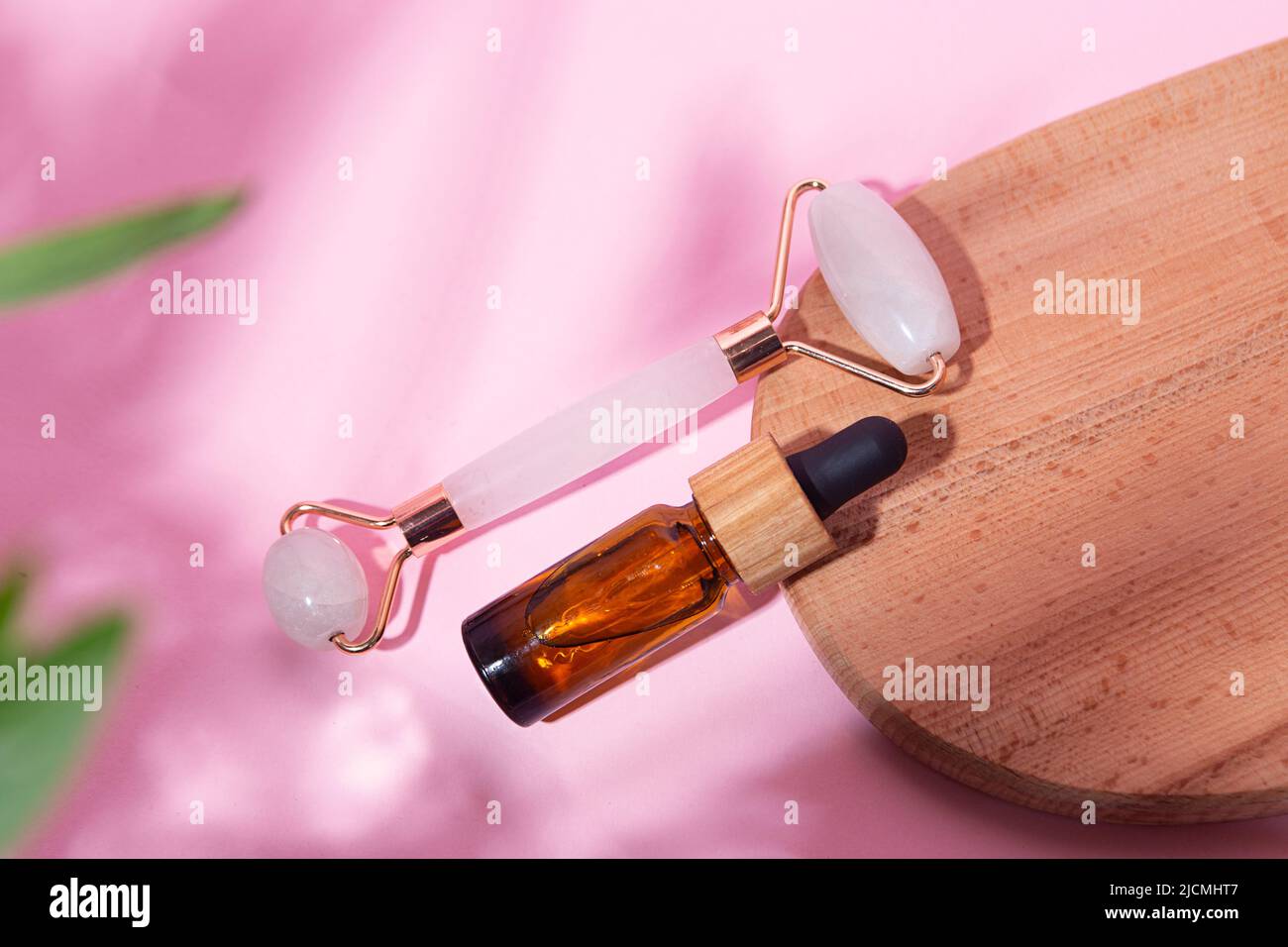 Top view of cosmetics face roller and dropper with oil near it.Self ...