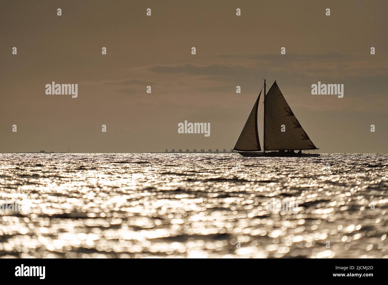 Classic sailing yacht in sea at sunset, the clear sky, sun reflection on water Stock Photo - Alamy