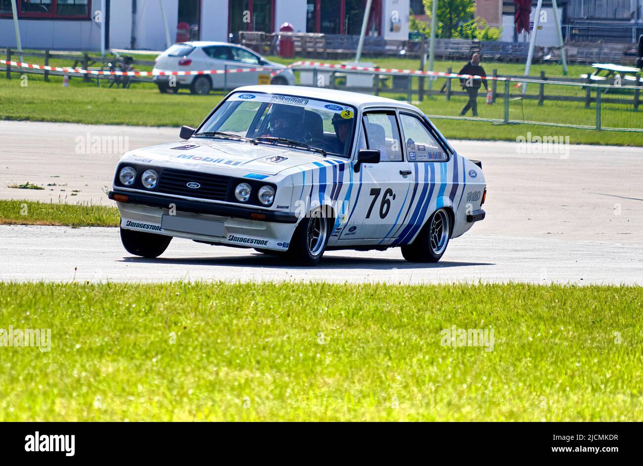 Ford Escort sports car in white cornering at an angle during vintage ...
