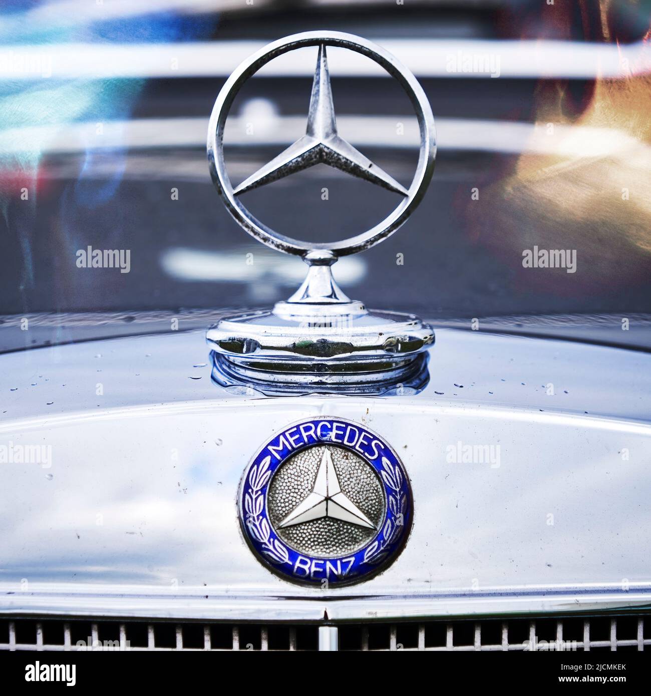Mercedes Benz lettering, logo and star on the hood of the classic car ...