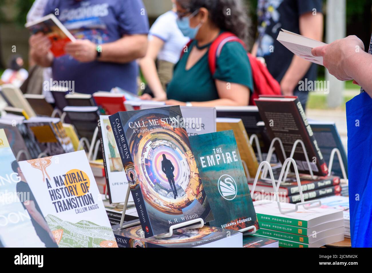 People browse books in a street kiosk during the Word On The Street ...
