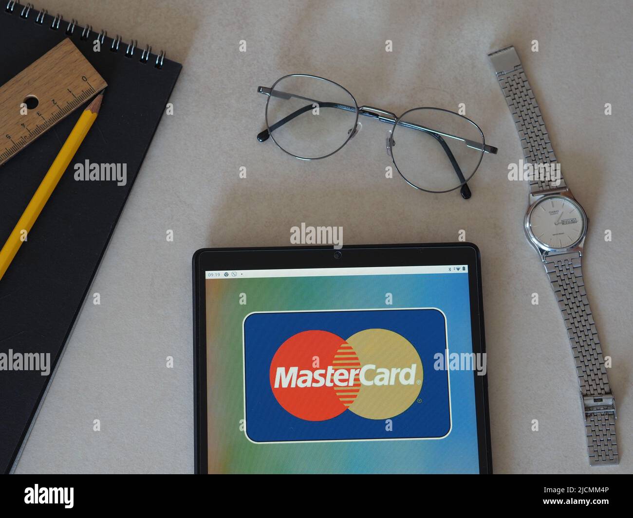 In this photo illustration MasterCard logo seen displayed on a tablet ...