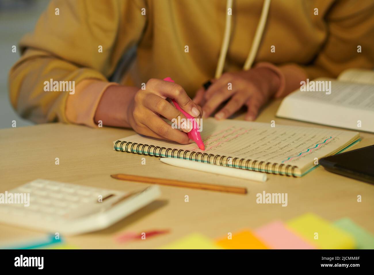 Hands of schoolgirl highlighting text on notebook when studying for ...