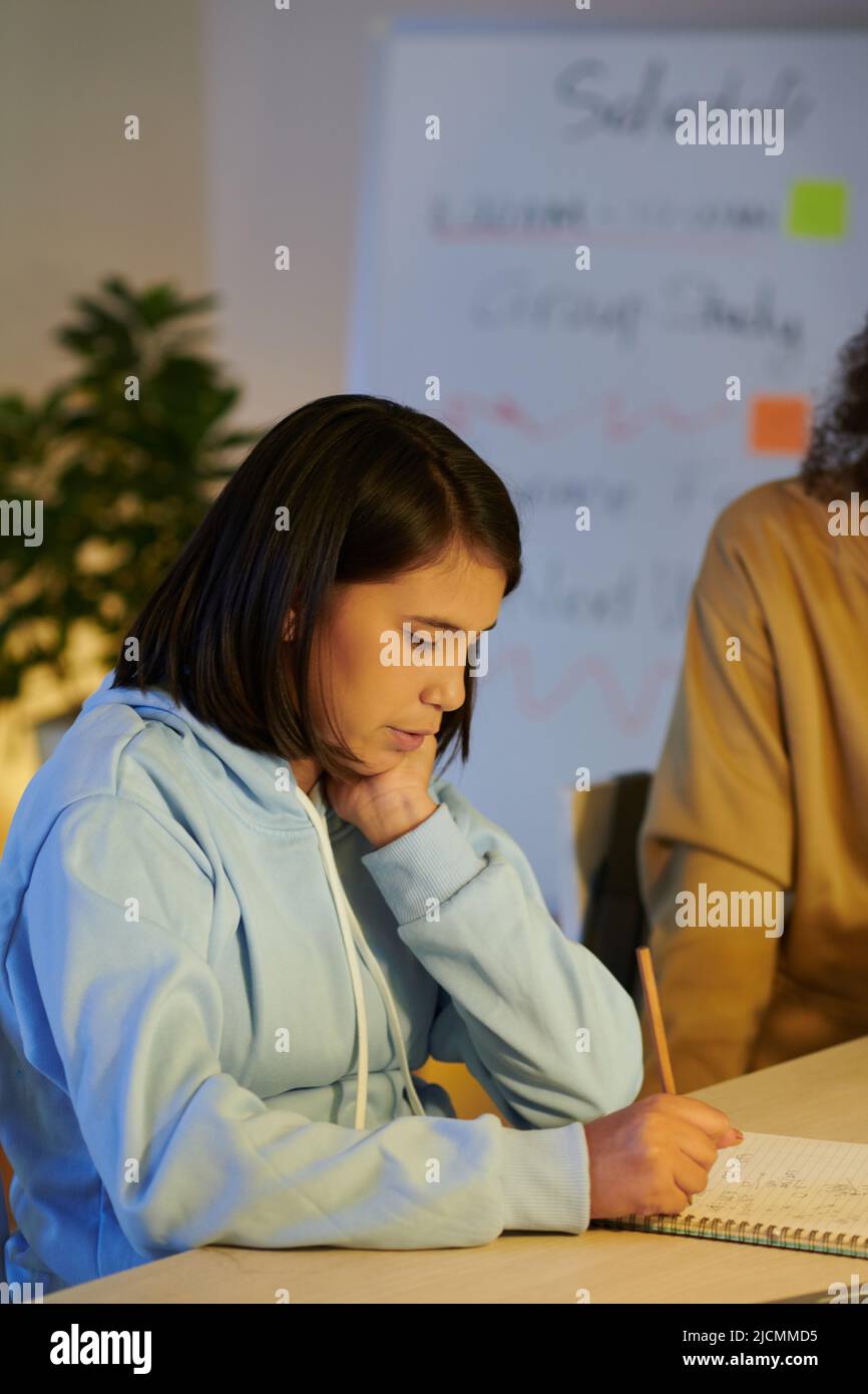 Pensive schoolgirl having difficulties with doing math homework Stock ...