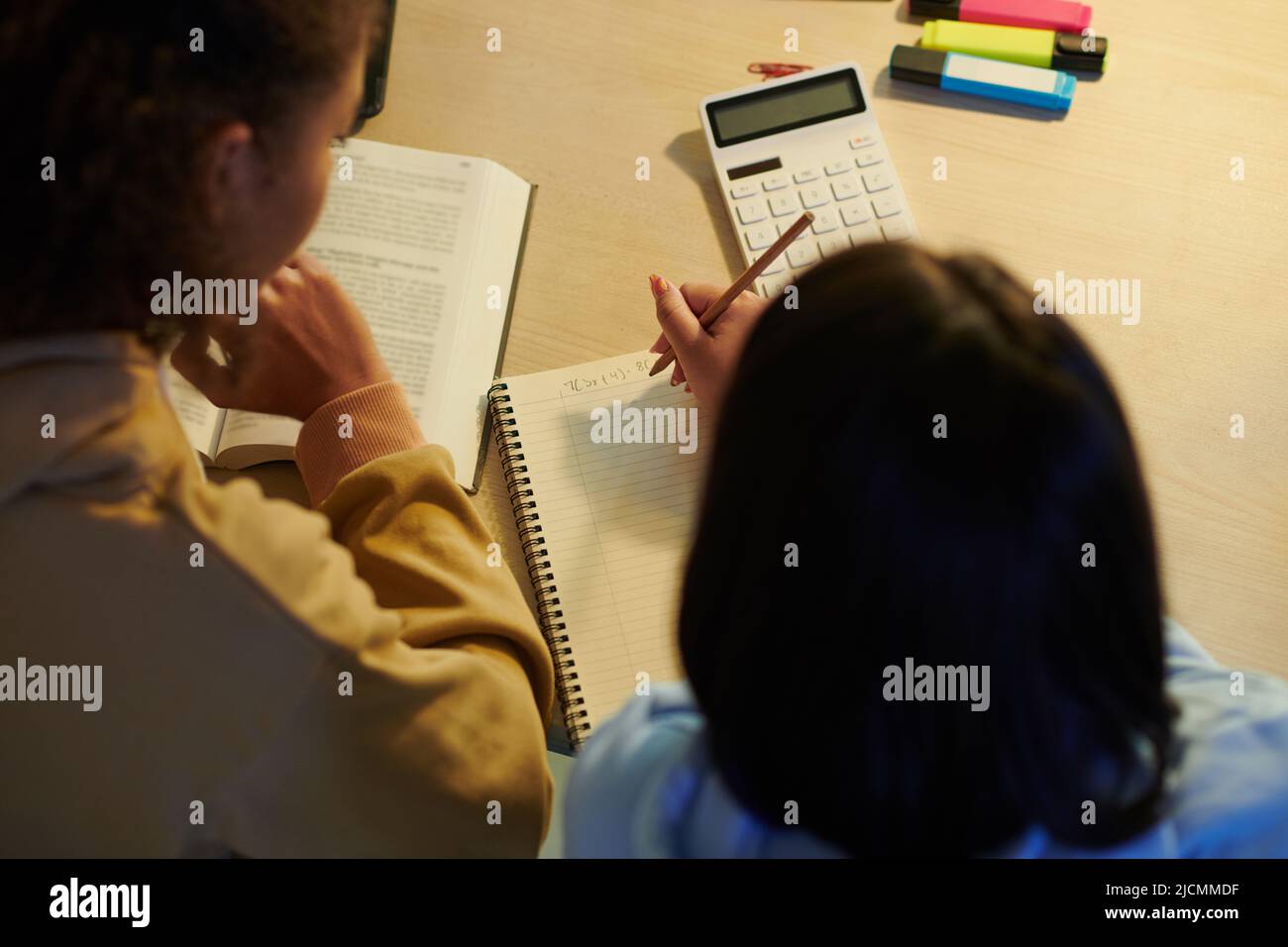 Schoolgirl asking sister to help with solving equations for math class ...