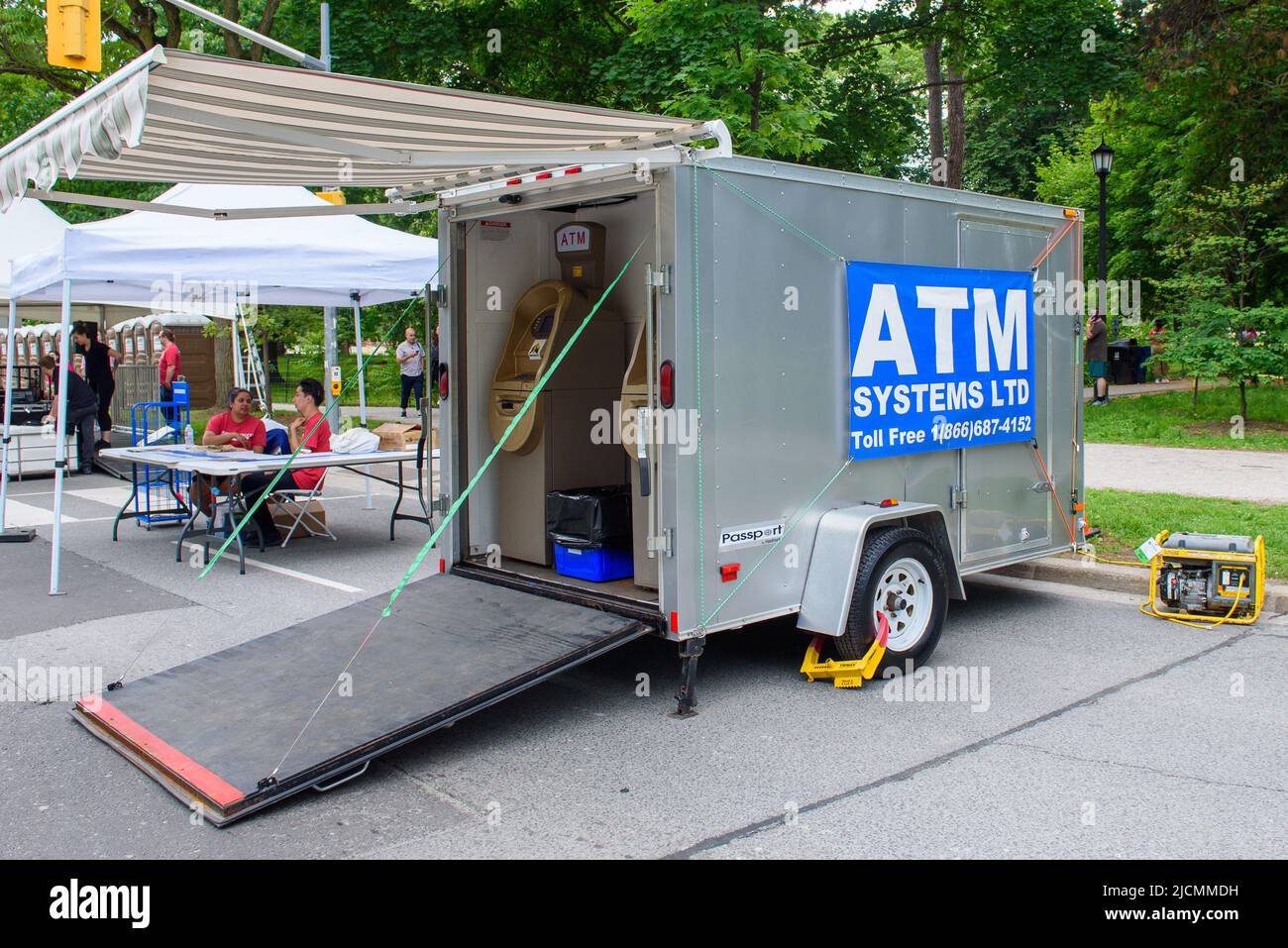 An ATM or Automated Teller Machines operates in a portable trailer cart ...