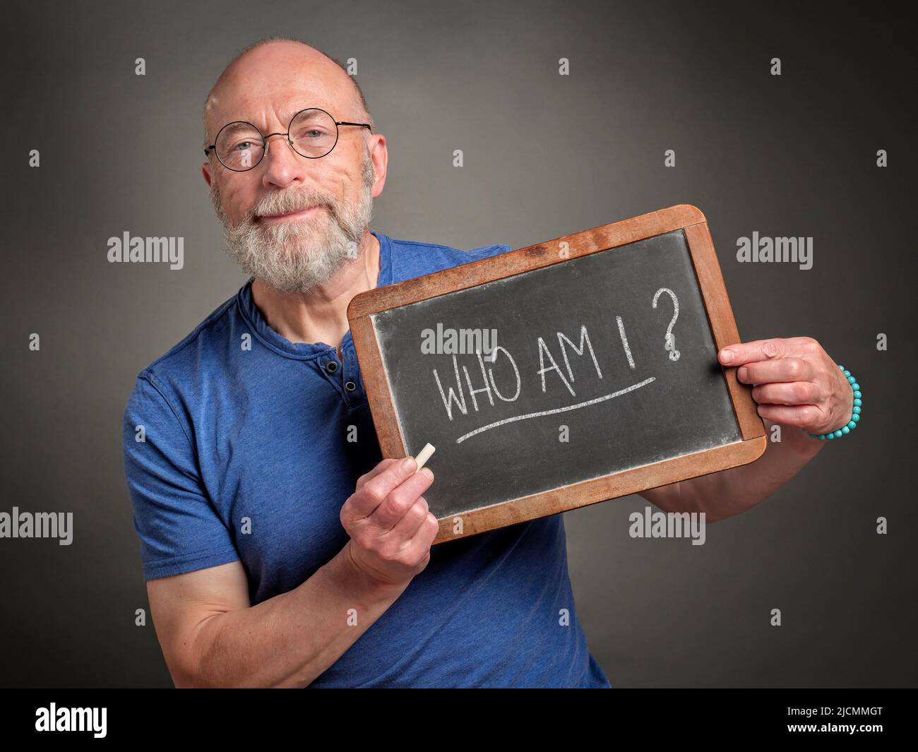 Who am I? Senior man is sharing inspirational question handwritten on a ...