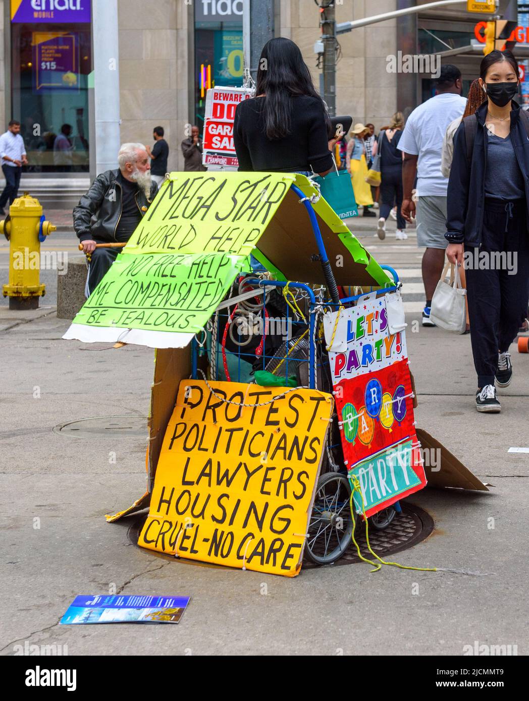 Sign protesting housing conditions in the city. One sign reads: Protest ...