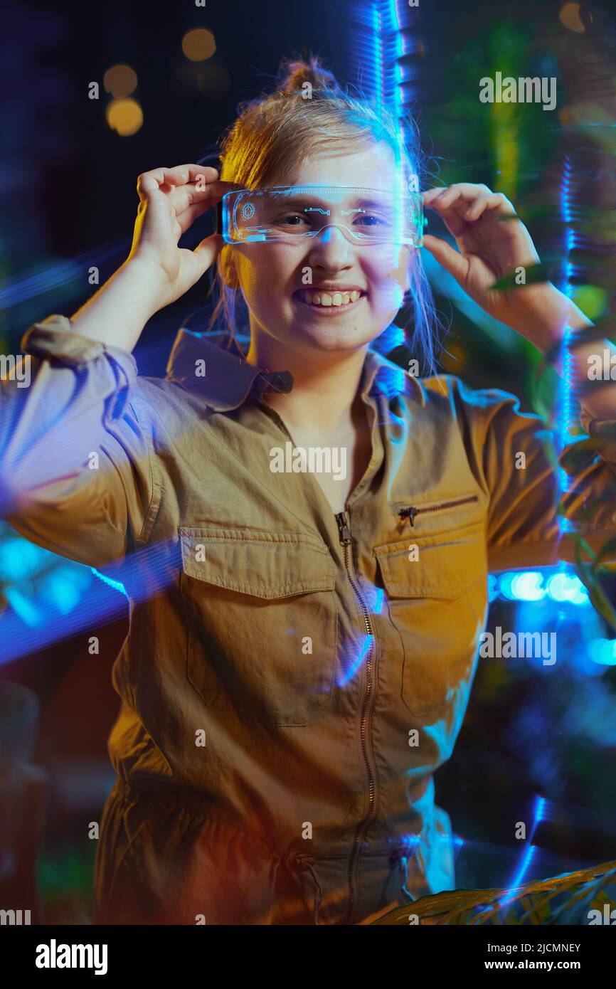 smiling modern child with toy gun and futuristic glasses in virtual ...