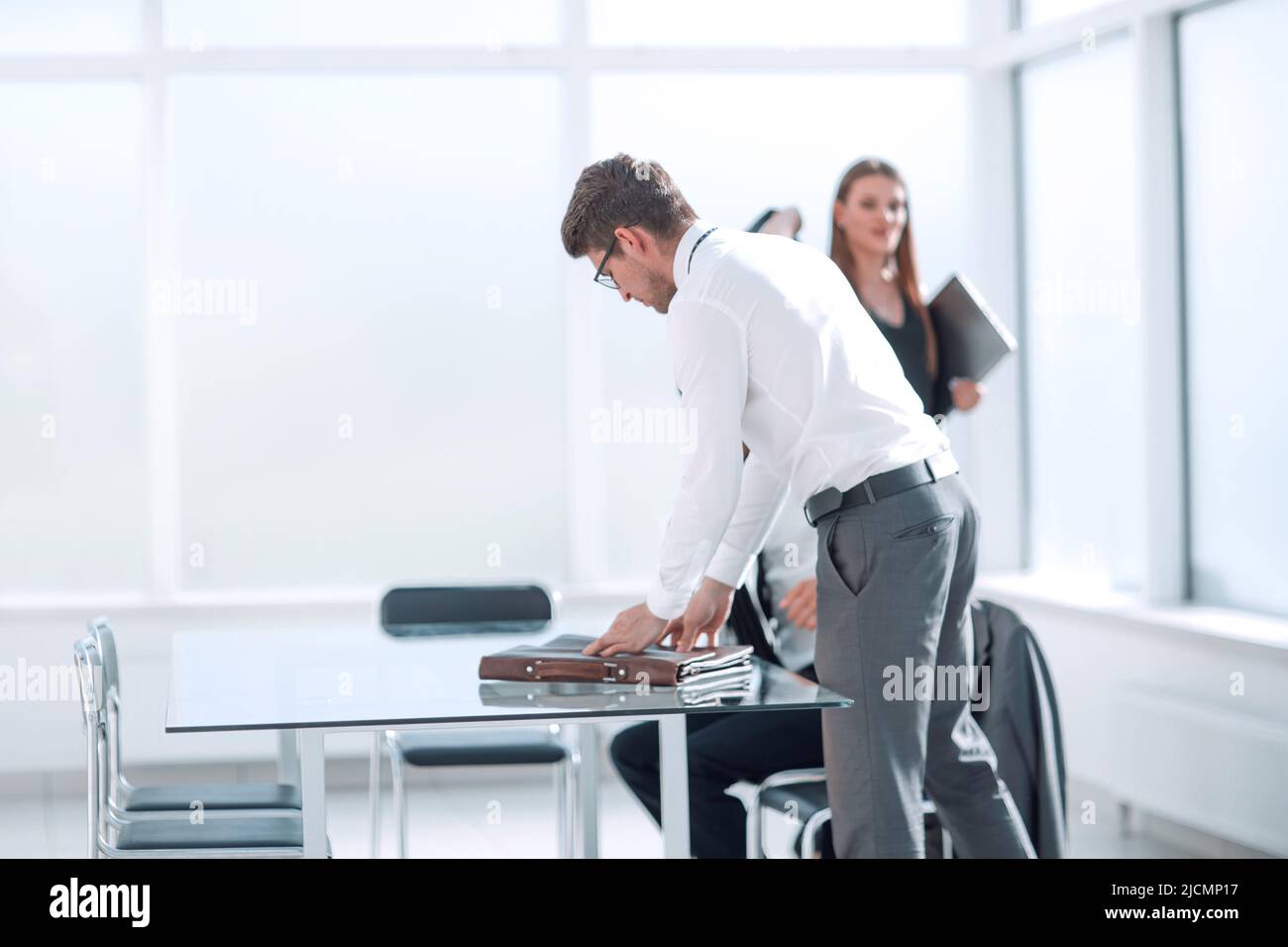 young employees completing their work in the office Stock Photo - Alamy