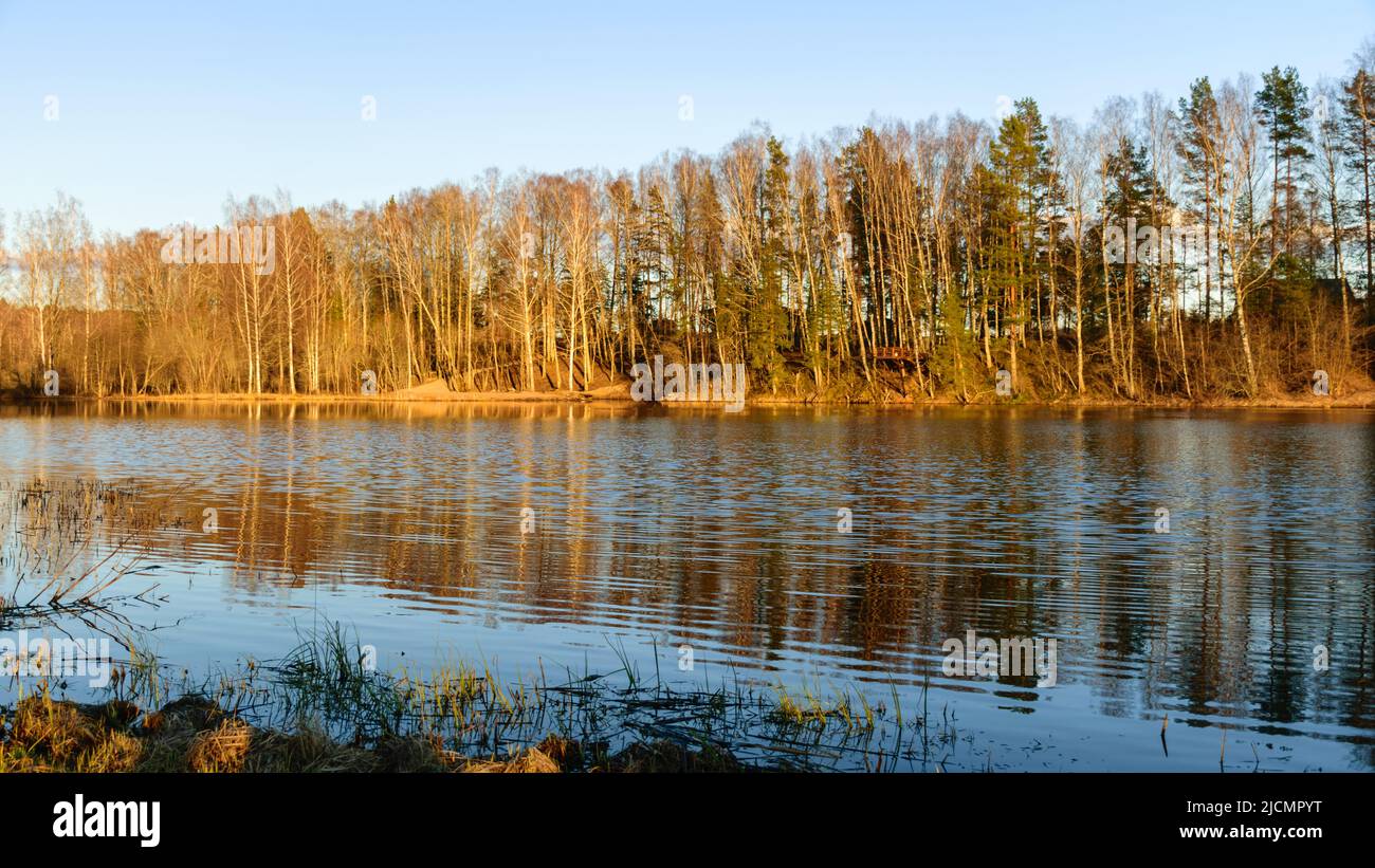 colorful spring landscape with reflections of lakes, clouds and trees ...