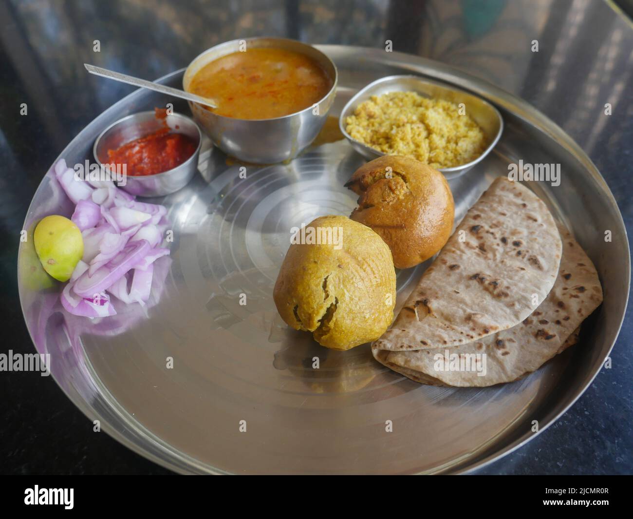 Dal bati rajasthani traditional vegetarian food plat in rural india ...