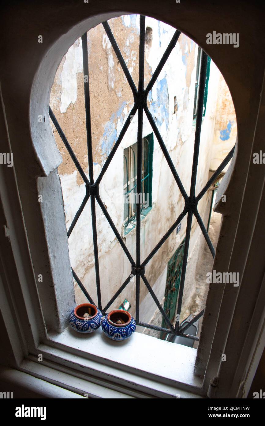 Typical Moroccan window in the form of an arch with ornaments and bars ...