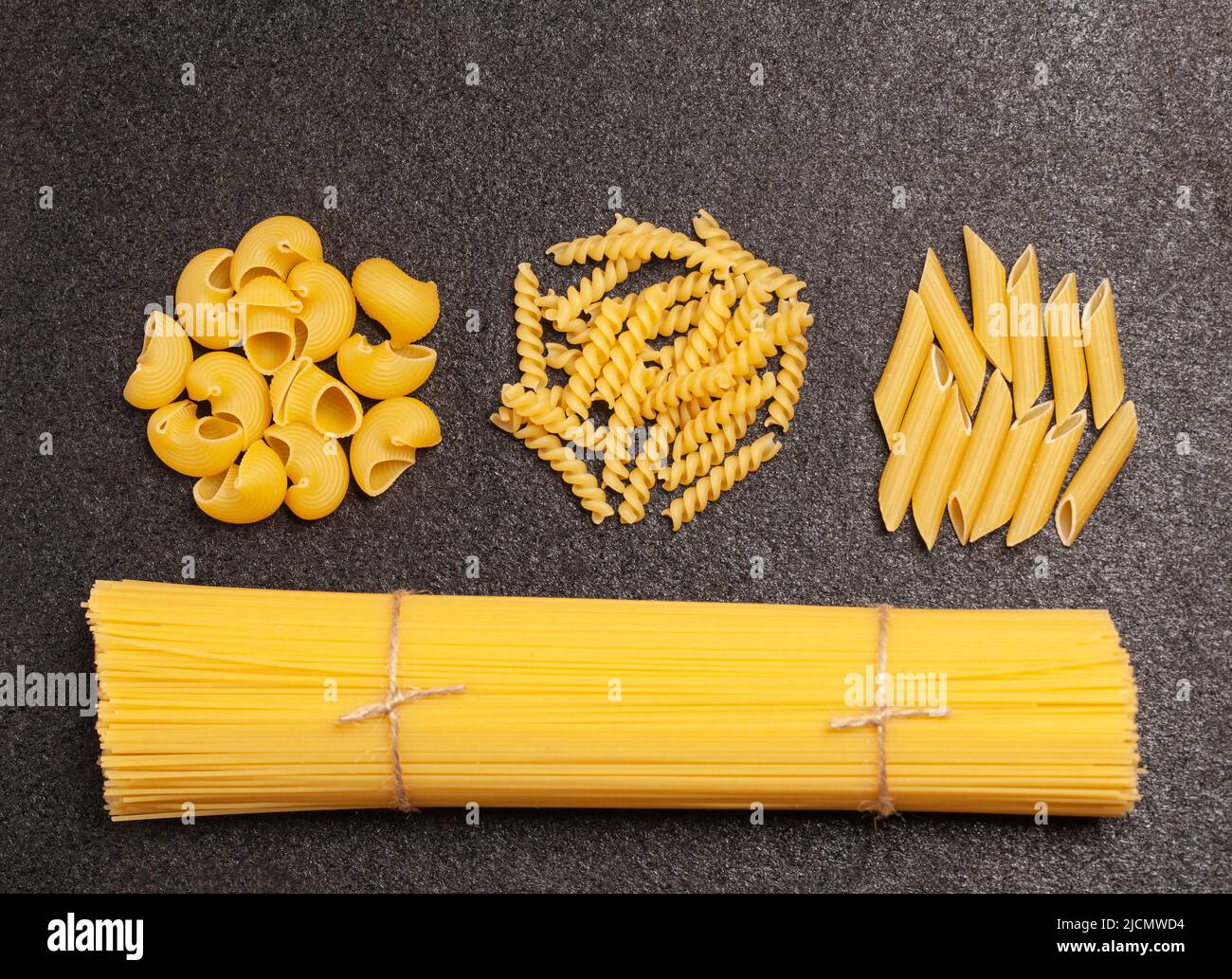 Spaghetti with variety of types and shapes of Italian pasta on black ...