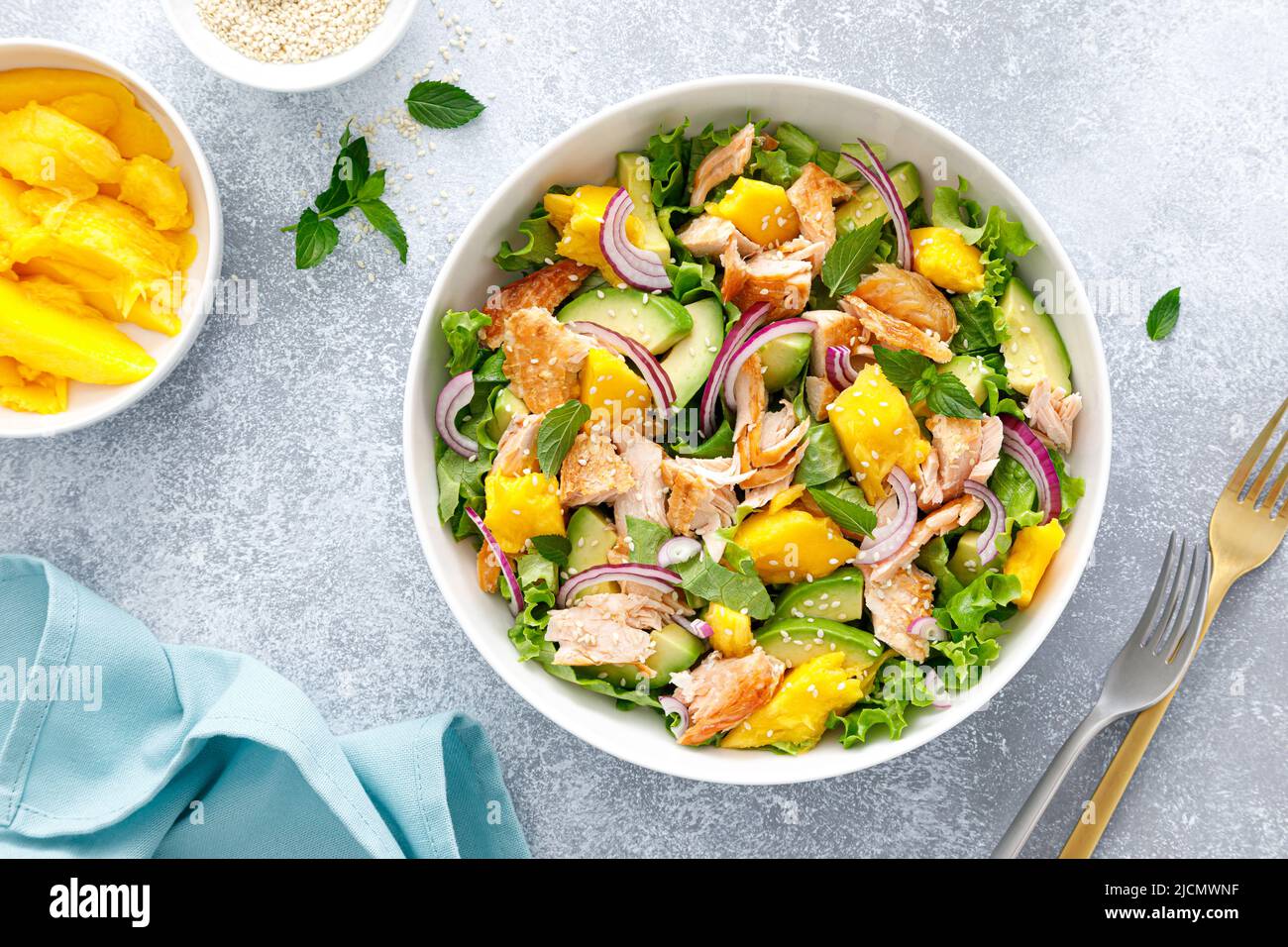 Grilled salmon and mango salad with avocado and fresh green lettuce ...