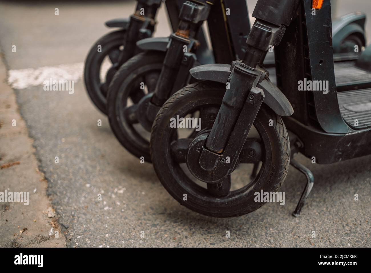 Modern electric scooter parking on the street Stock Photo - Alamy