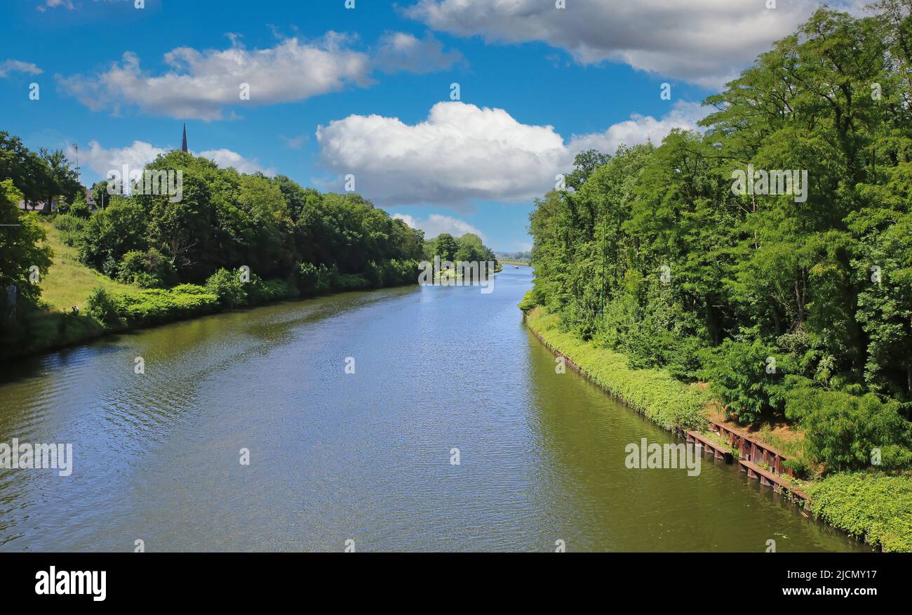 Beautiful dutch water canal at river Maas mouth, green forest, blue ...