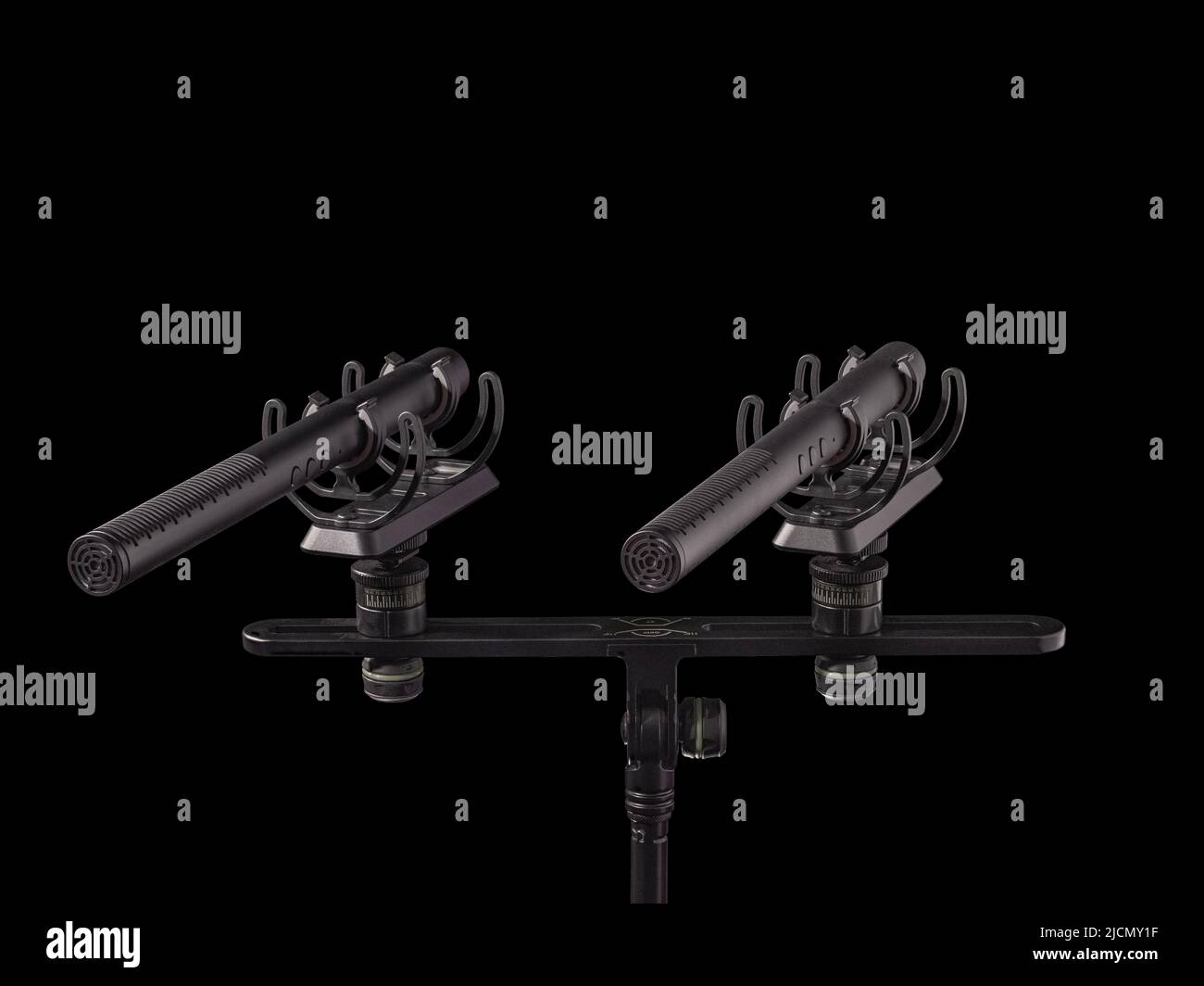 Microphones matched pair on shock mount stereo bar isolated on black ...