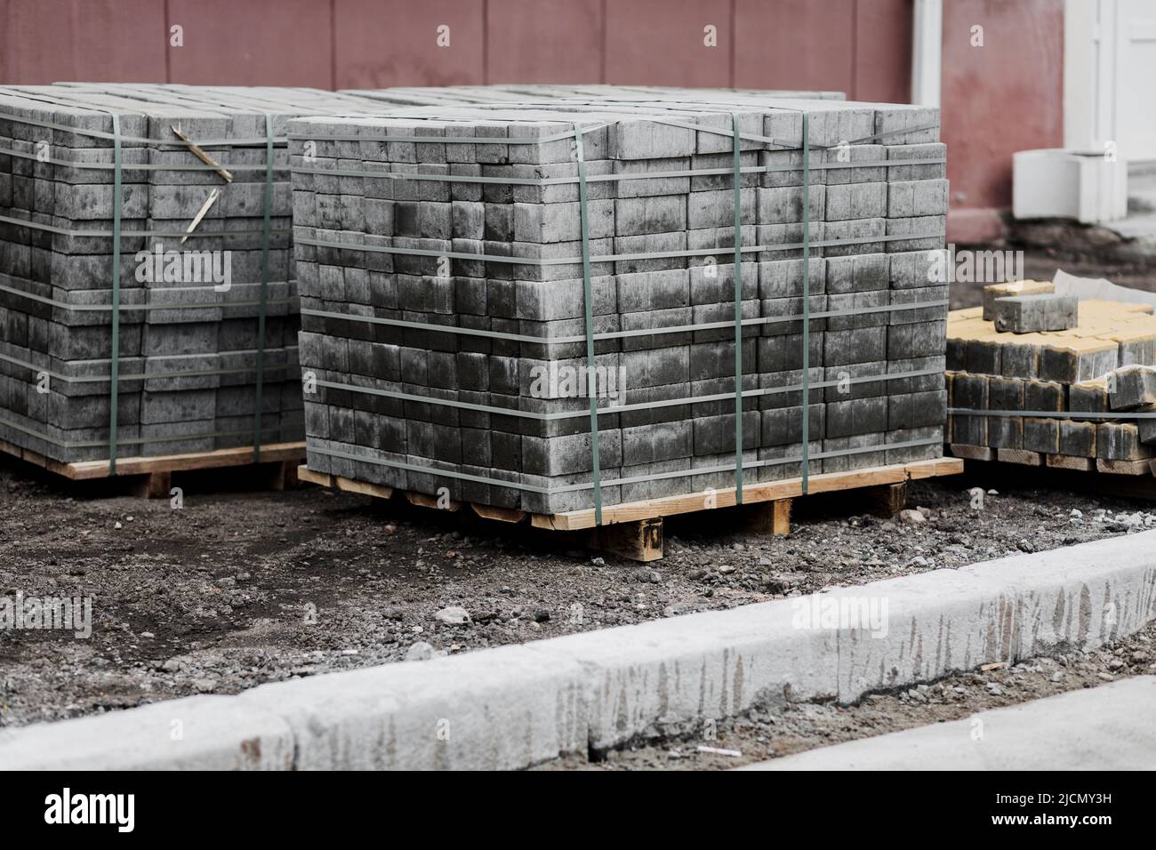 New paving slabs neatly stacked on pallets. Sidewalk tile. Construction ...