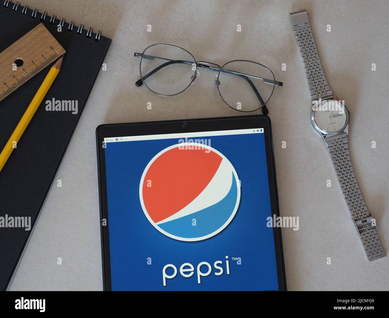 In this photo illustration Pepsi logo seen displayed on a tablet Stock ...