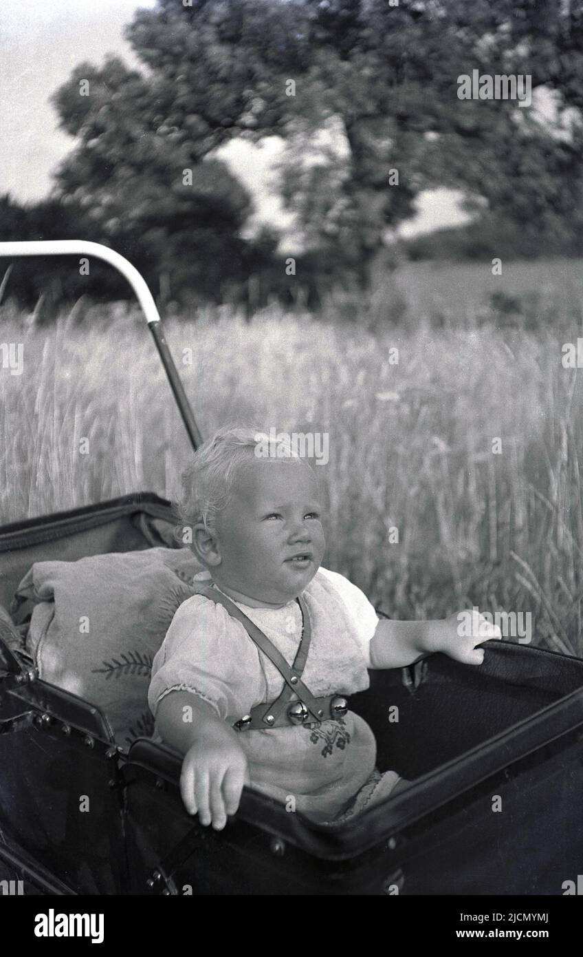 1950s, historical, outside in the open air, in a country field, an ...