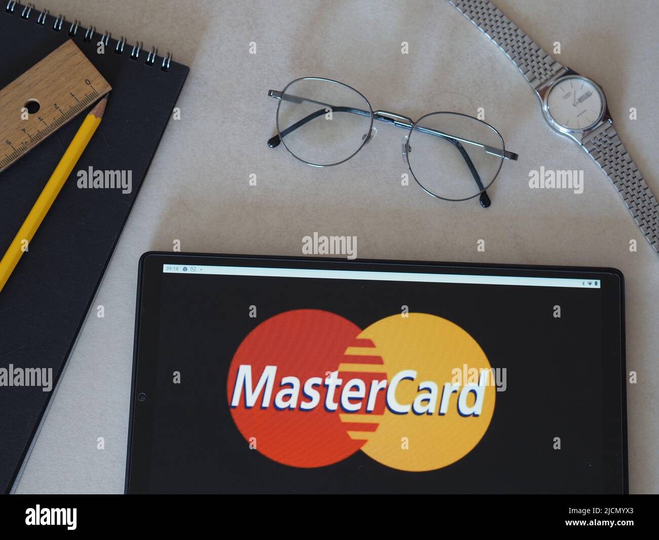 In this photo illustration MasterCard logo seen displayed on a tablet ...
