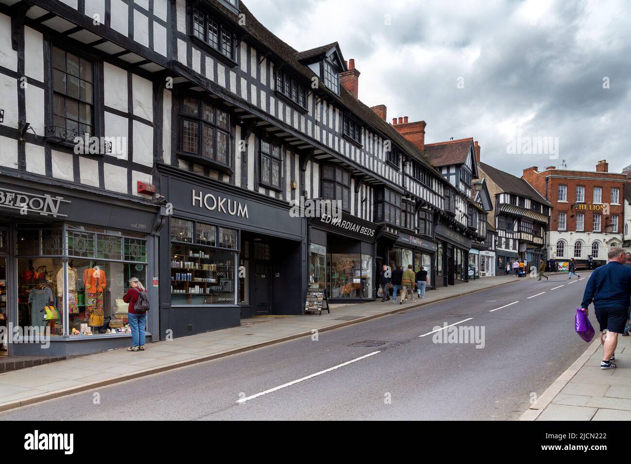 Shoppers on an English High street lined with Tudor architecture Stock ...