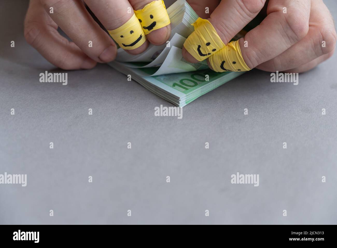 A man's fingers are counting the money. A wad of euro bills. The index ...