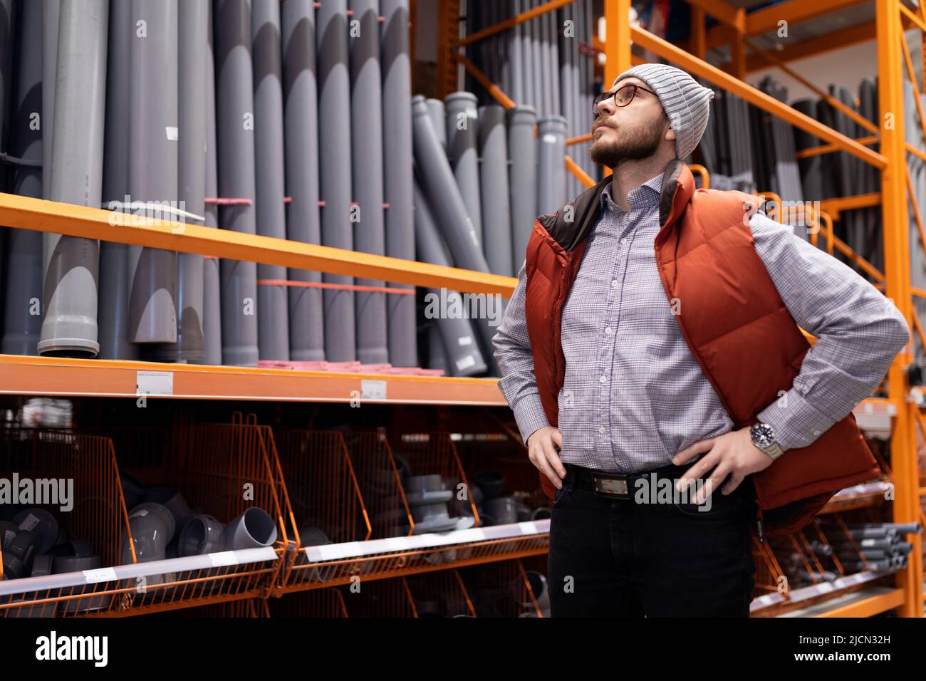 Buyer in hardware store chooses sewer pipes Stock Photo - Alamy