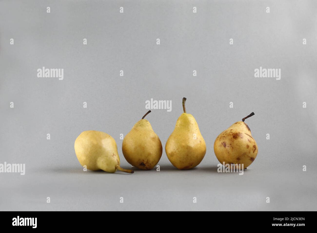 healthy eating concept - four pears isolated on gray background Stock ...