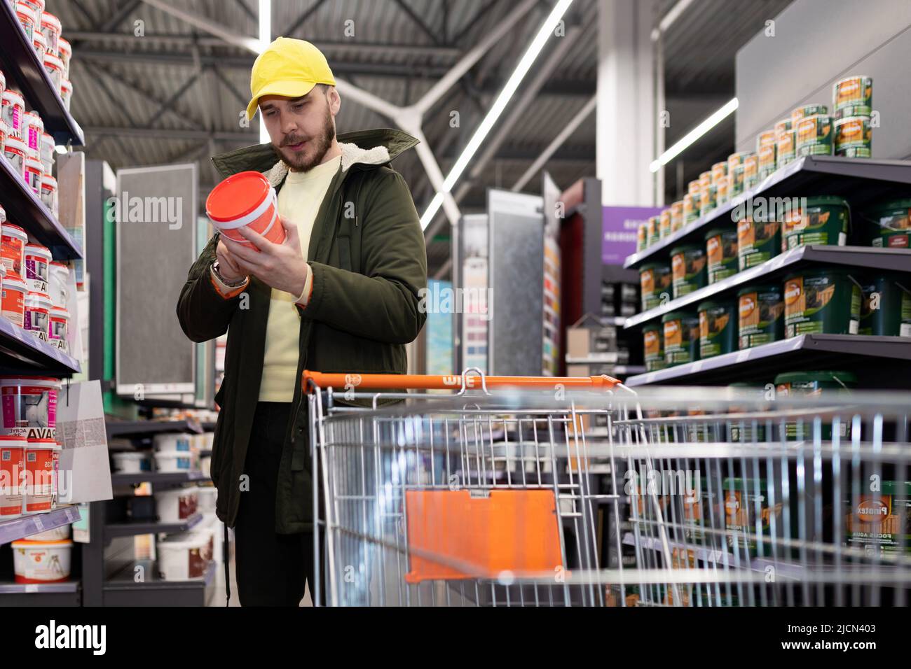 the buyer chooses paint for interior work in the store of finishing ...