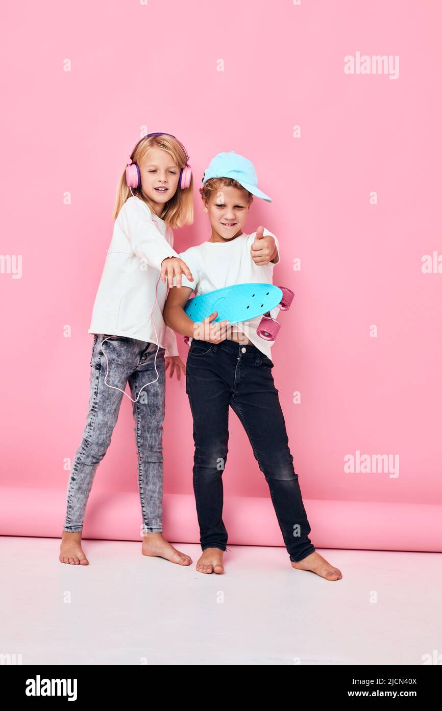 Portrait of two young smiling kids Play more fun together studio Stock ...