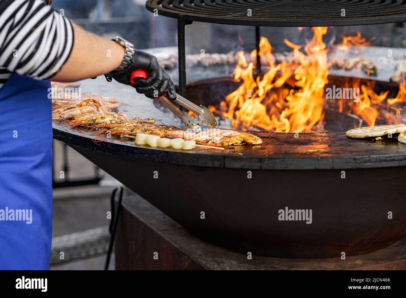 Barbecue grill, fire, flame. Man cooking seafood, summer picnic in ...