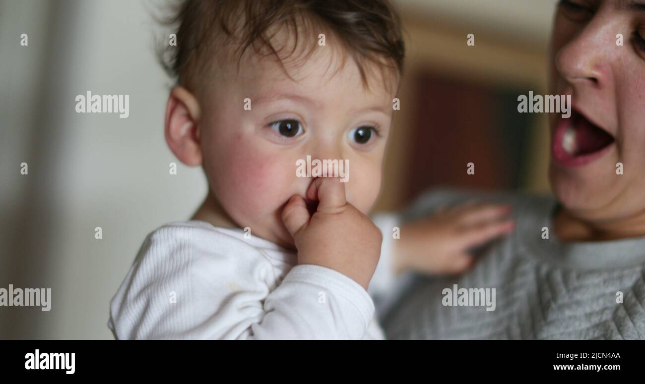 Tired mother and baby, mom yawning, infant wanting to sleep rubbing eye ...