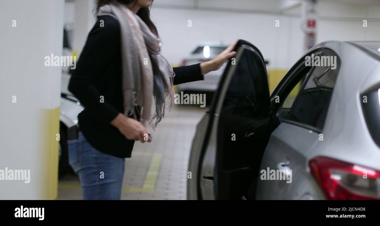 Woman driver getting out of car after parking vehicle. Person opening ...