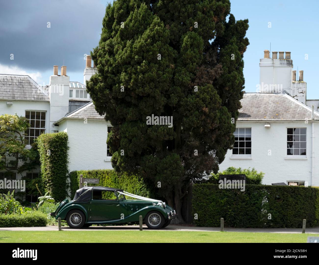 White cute cottage with green vintage car in Richmond park,London Stock ...