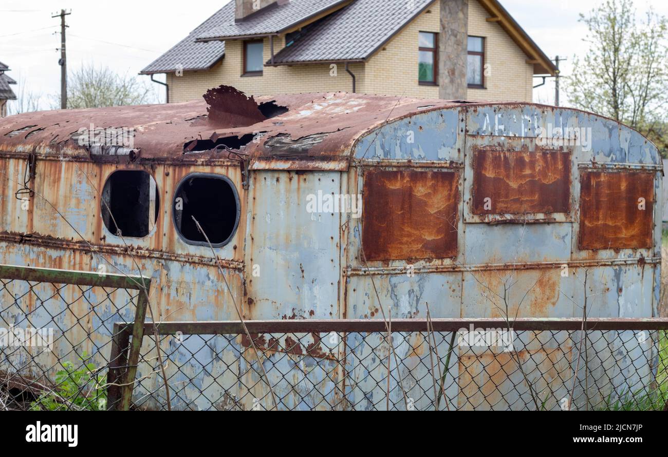 A dilapidated rotten and rusty metal hut on a work site. An old tin ...